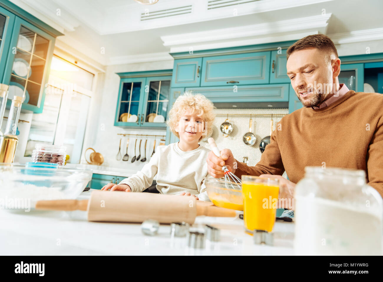Positive happy father and son cooking together Stock Photo - Alamy