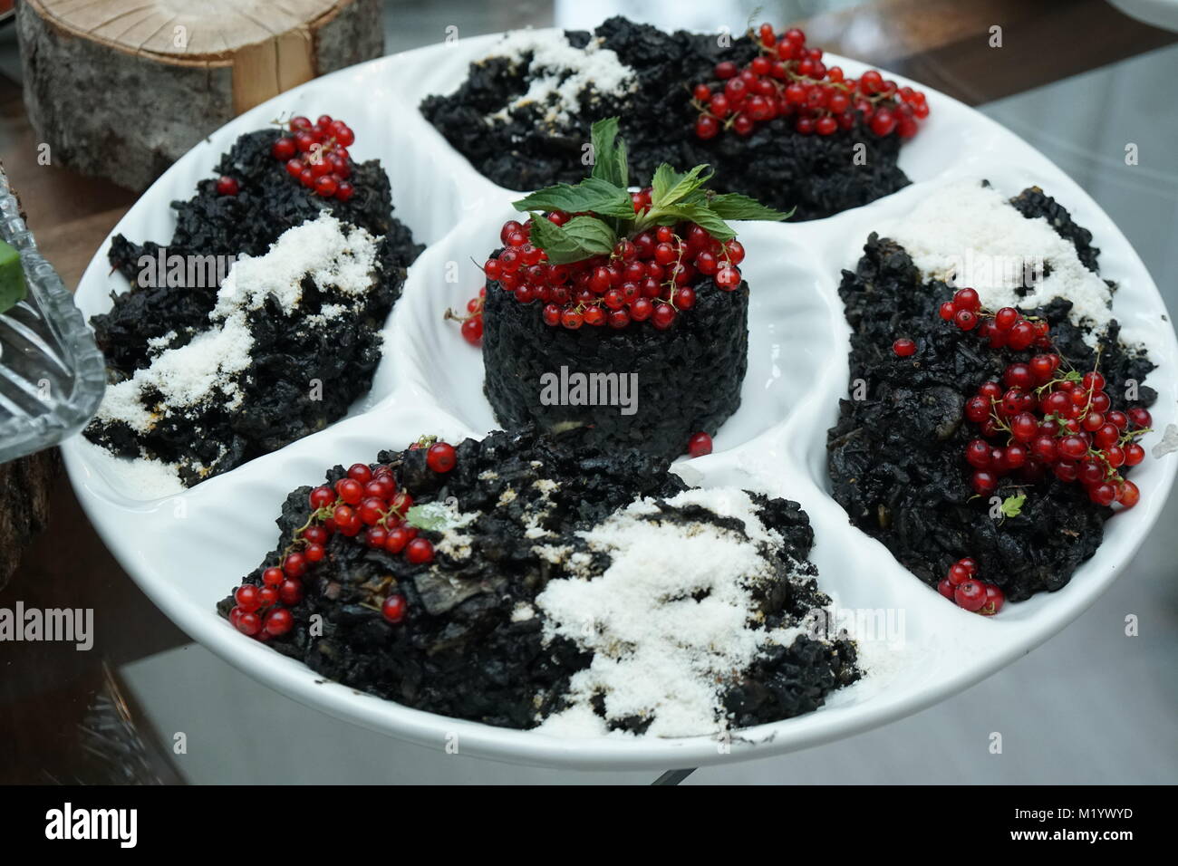 Black risotto with currants Stock Photo - Alamy