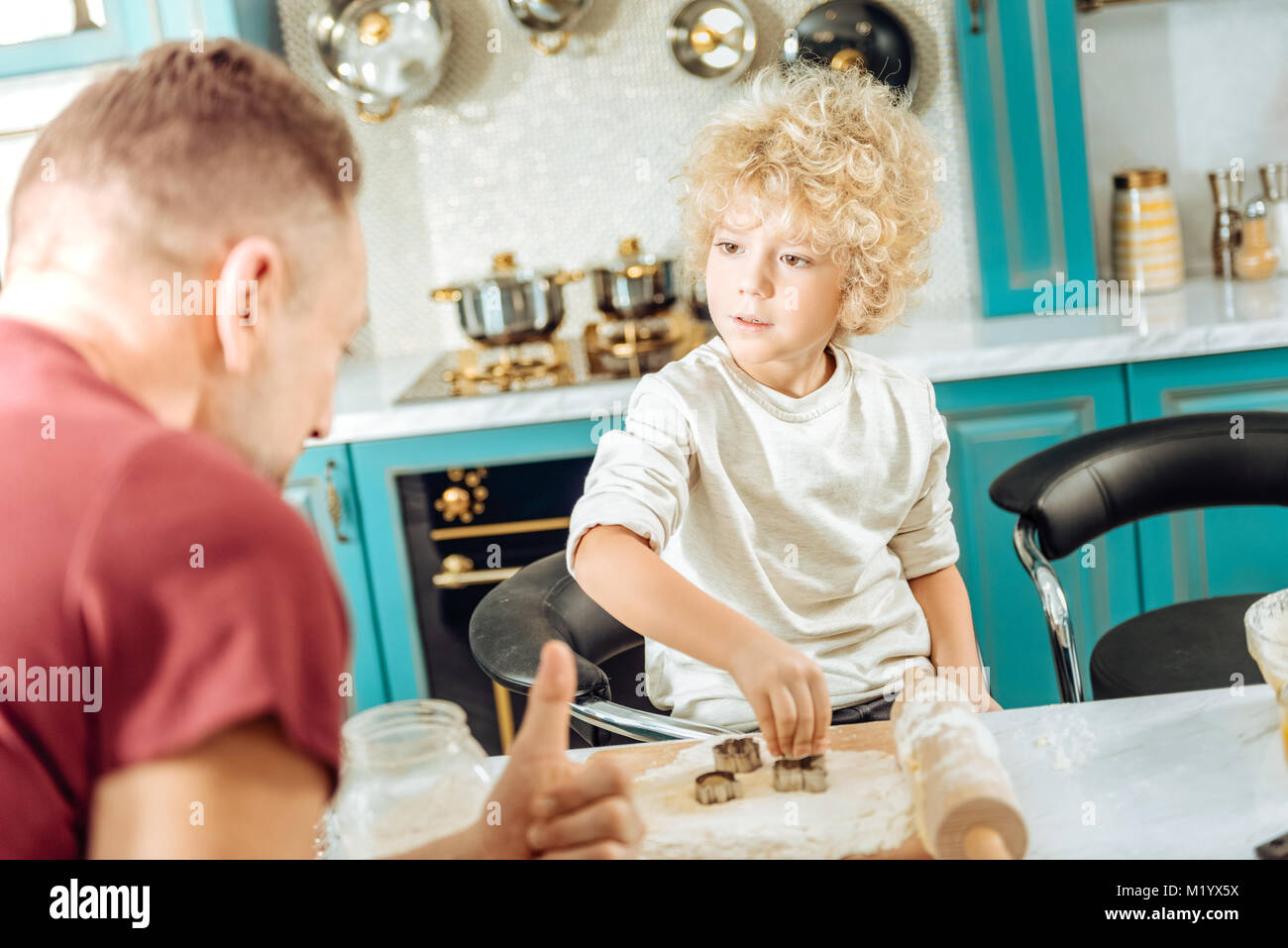 Nice young boy looking at his father Stock Photo - Alamy