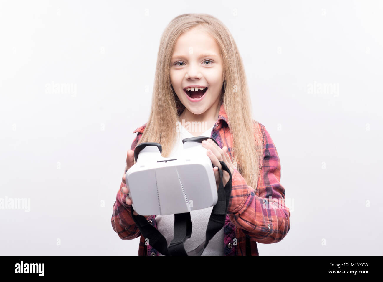 Cute little girl posing with a VR headset Stock Photo - Alamy
