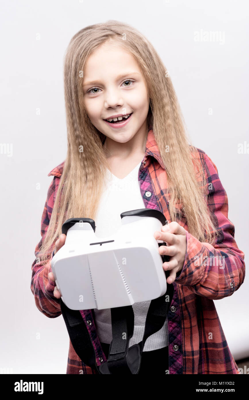Cheerful little girl holding a VR headset Stock Photo - Alamy