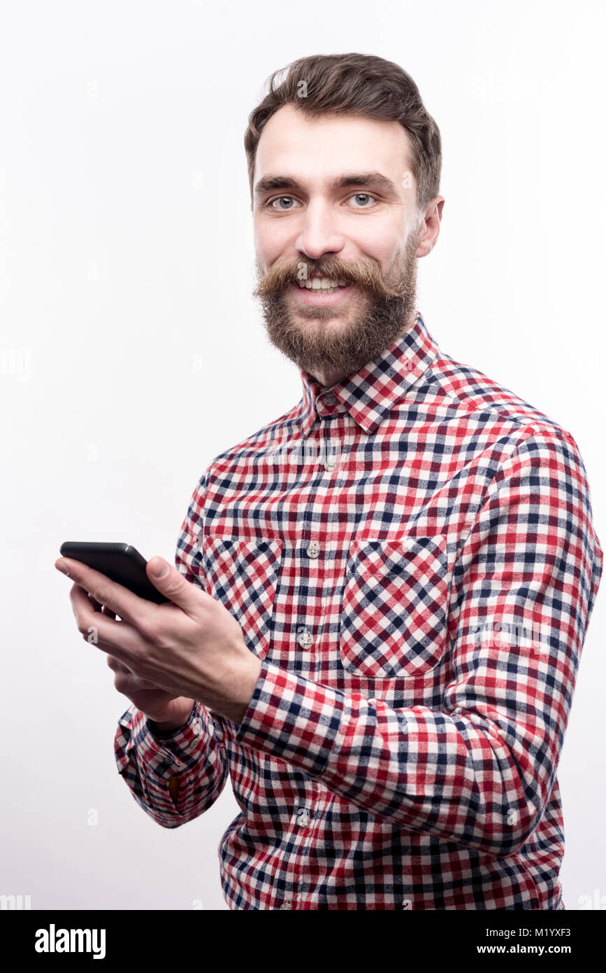 Smiling man posing while texting someone Stock Photo - Alamy
