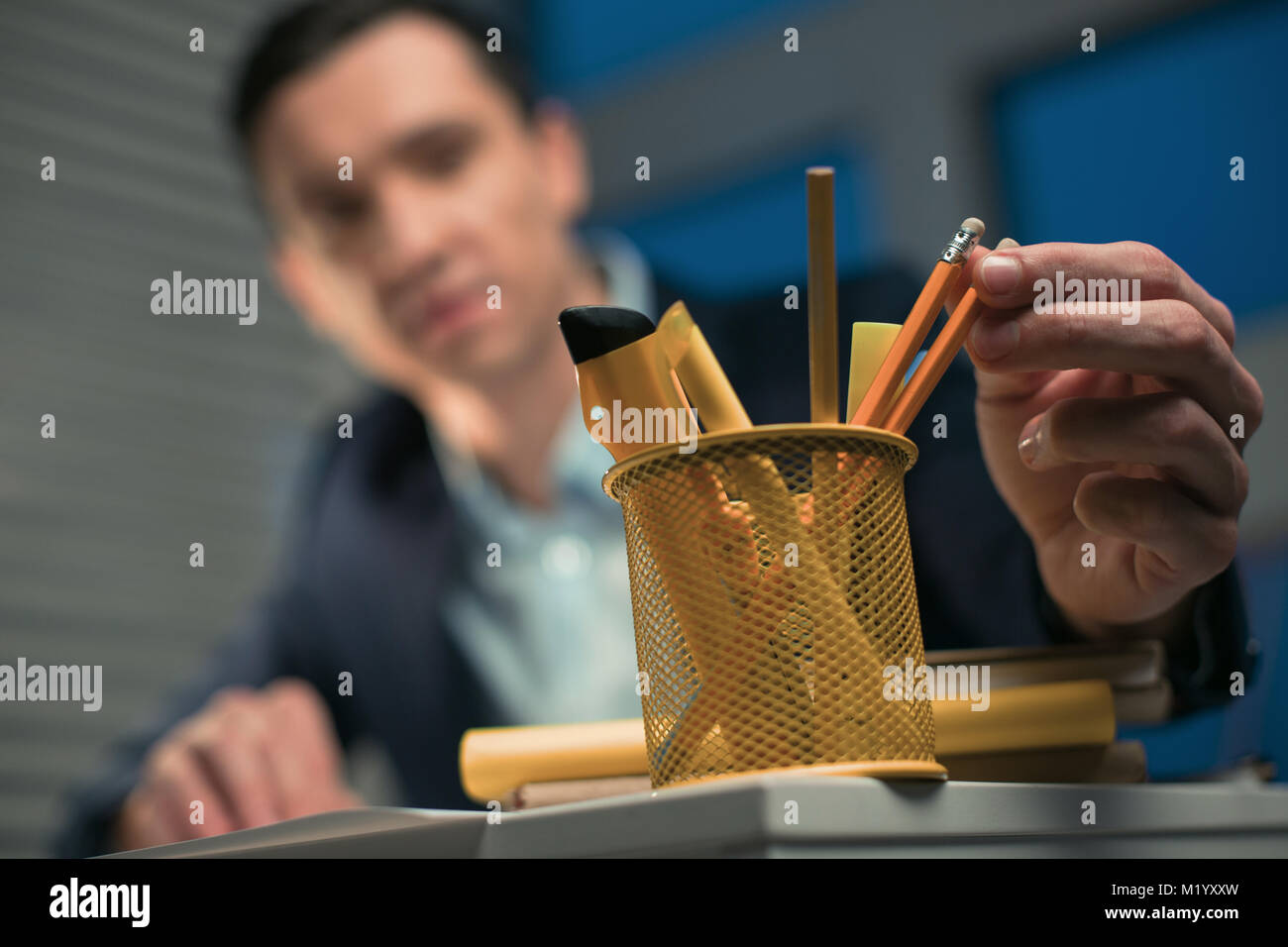 Young male engineer taking pencil Stock Photo - Alamy