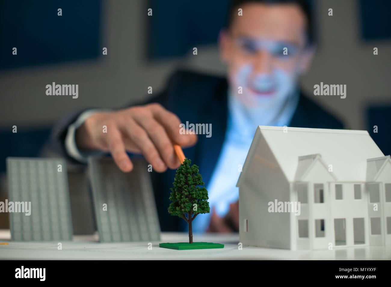 Young male engineer correcting model Stock Photo - Alamy