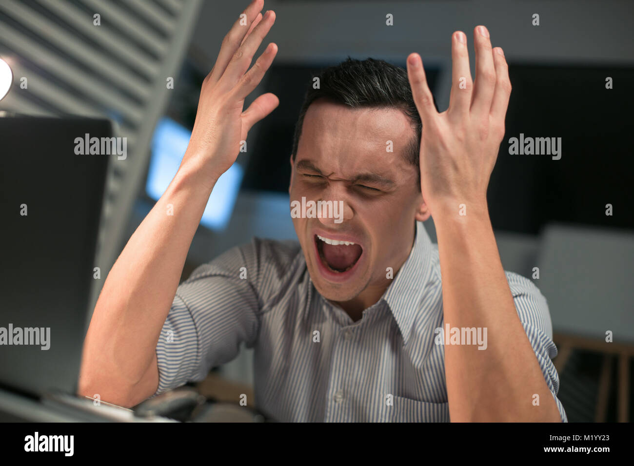Emotional male employee loosing his mind Stock Photo - Alamy