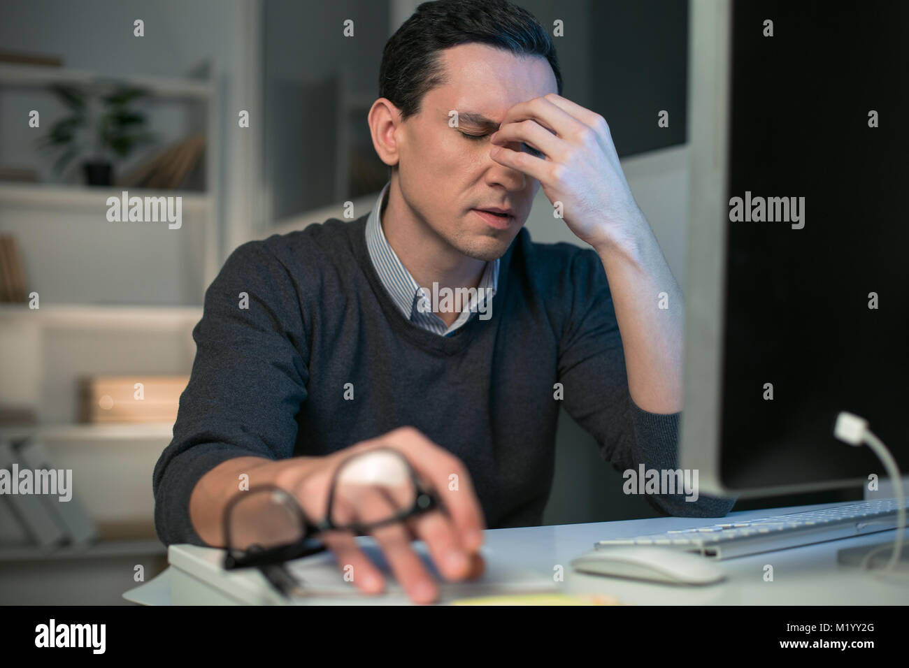Tired male programmer giving rest for eyes Stock Photo - Alamy