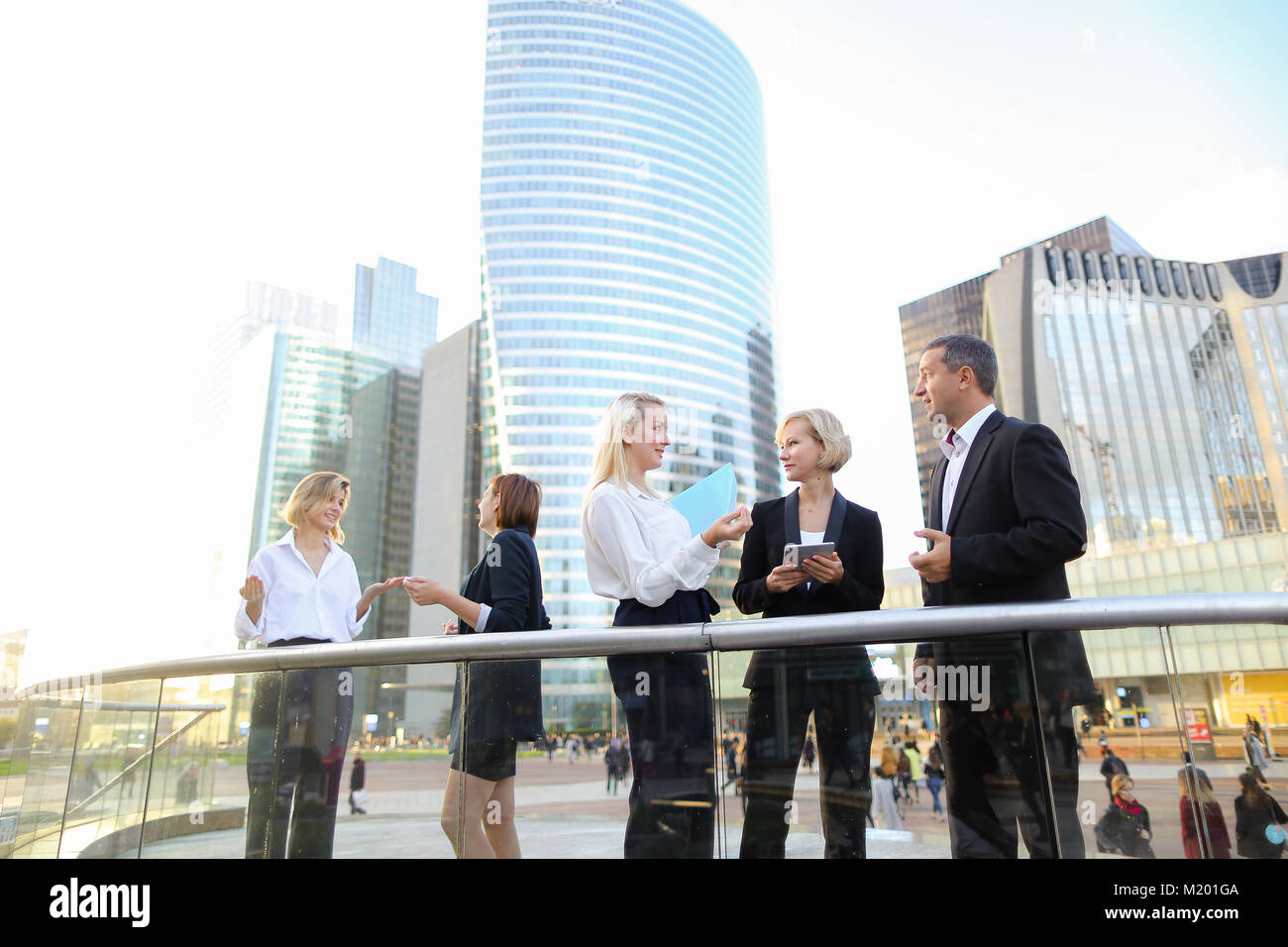 Businesswomen speaking with male boss outside Stock Photo - Alamy