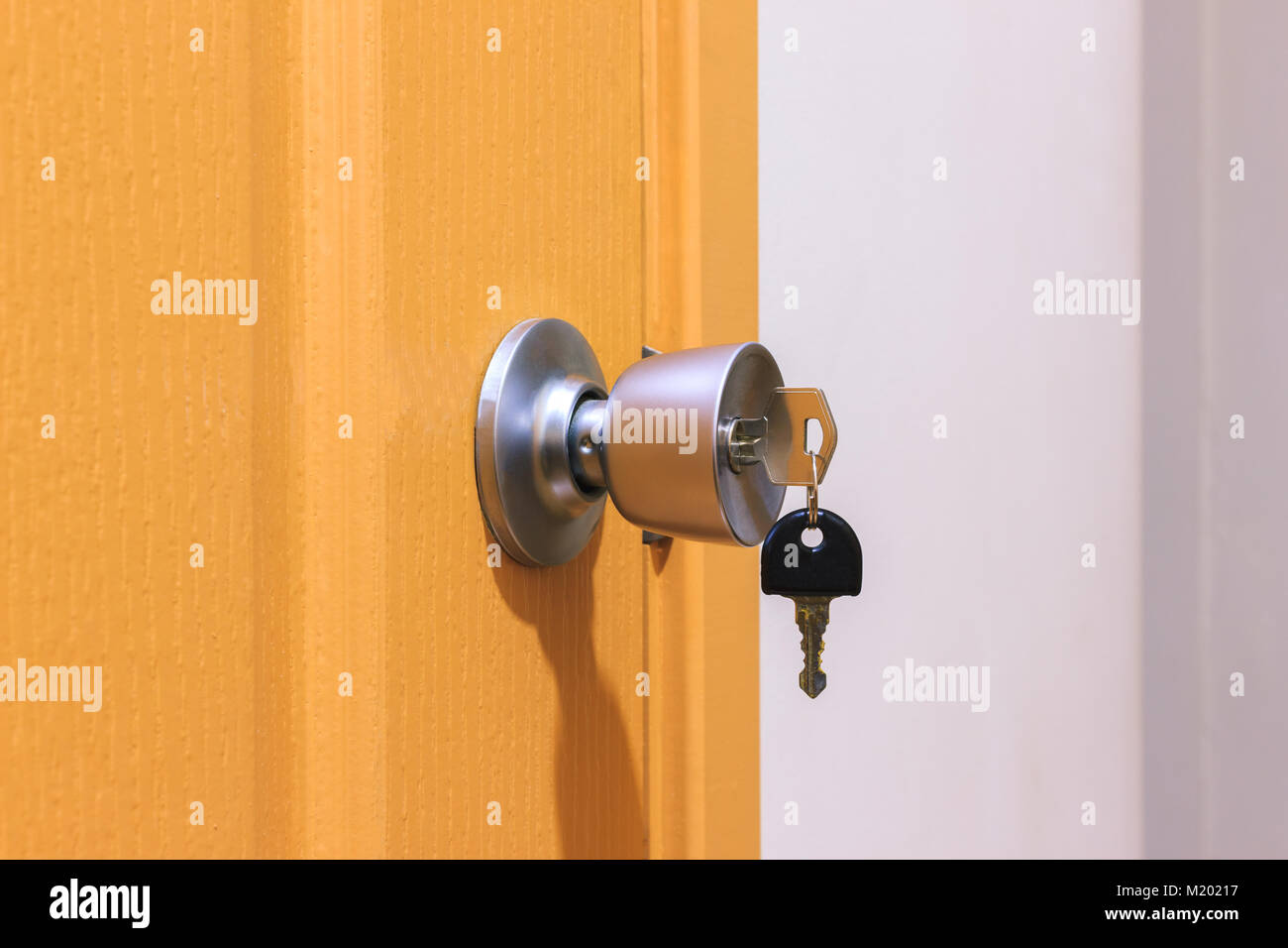 Key in keyhole on door Stock Photo - Alamy