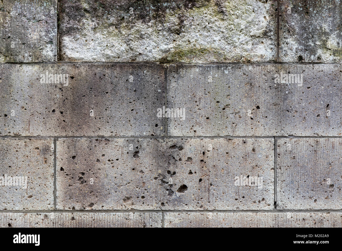 Rough texture of a partly disintegrated concrete brick wall; Tokyo ...