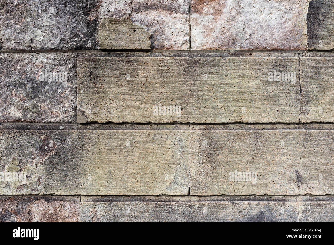 Rough texture of a partly disintegrated concrete brick wall; Tokyo ...