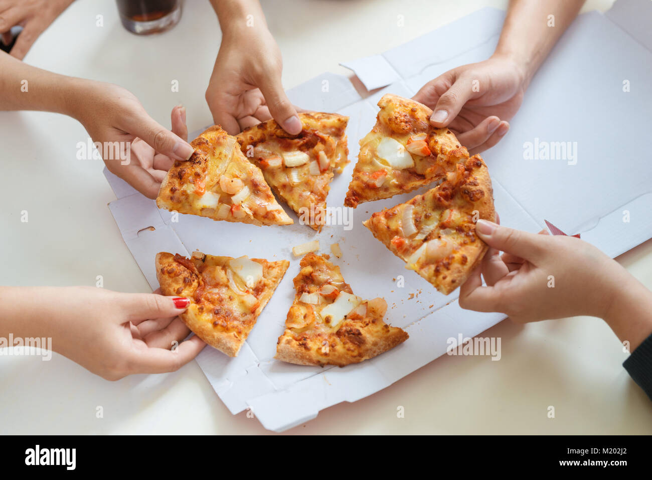 People eat fast food. Friends hands taking slices of pizza Stock Photo ...