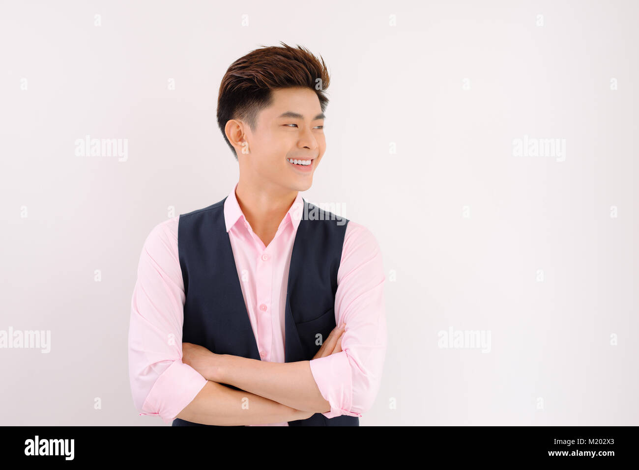 Handsome asian man stand and smile posing on gray background Stock ...