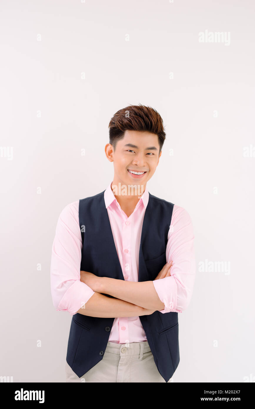 Handsome asian man stand and smile posing on gray background Stock ...