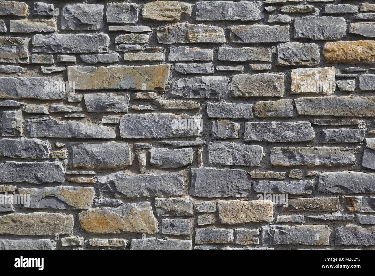Grey tiled stone wall, construction material Stock Photo - Alamy
