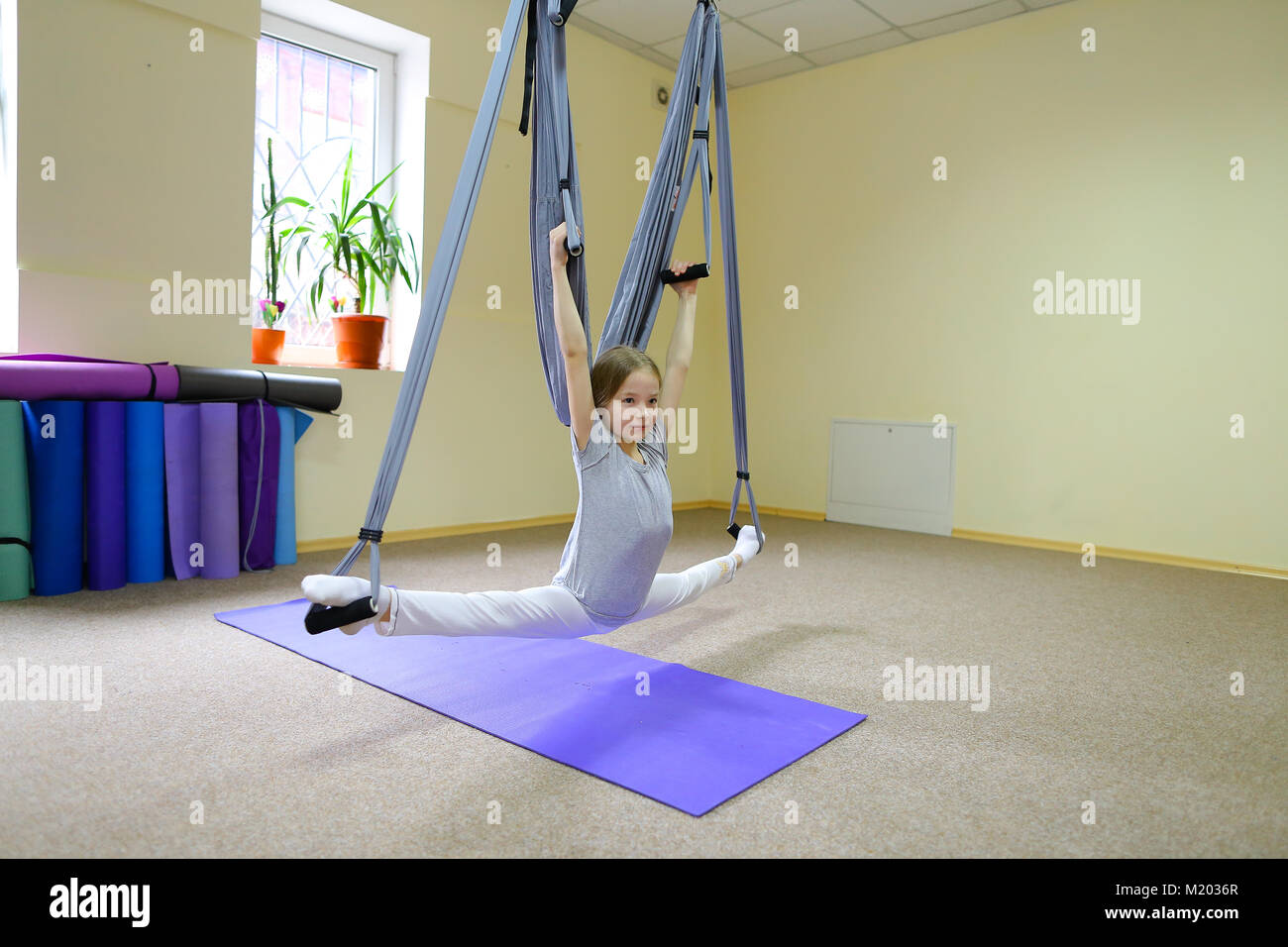 Little girl performs in air acrobatic elements Stock Photo - Alamy