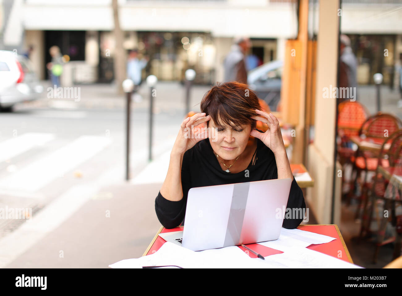 aged female screenwriter working with scenario in laptop Stock Photo ...