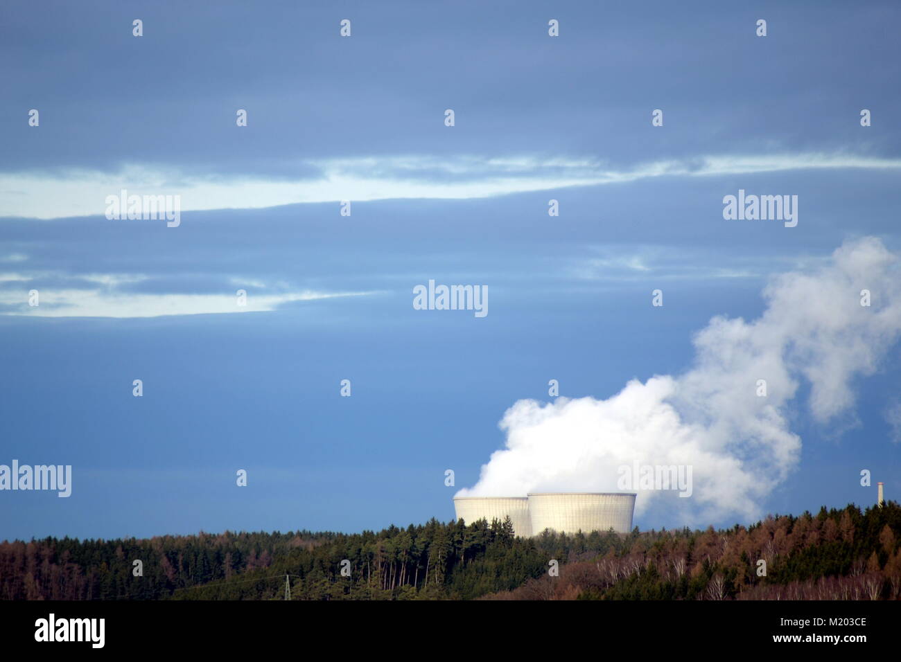 A nuclear power station in a forest with blue sky and steam Stock Photo ...
