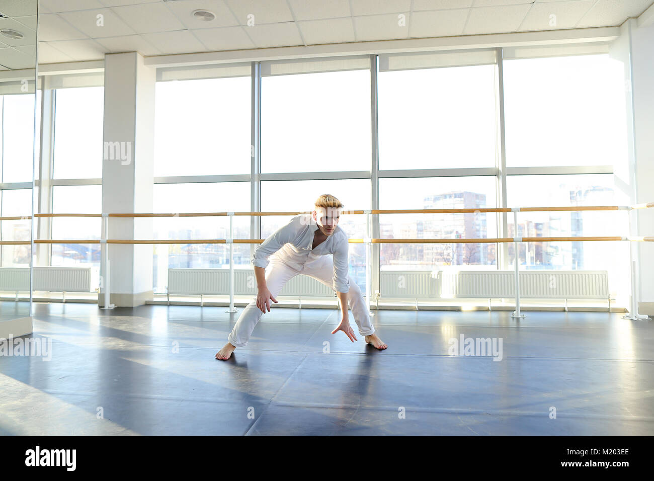 Guy spotting in white suit and raving at studio Stock Photo - Alamy