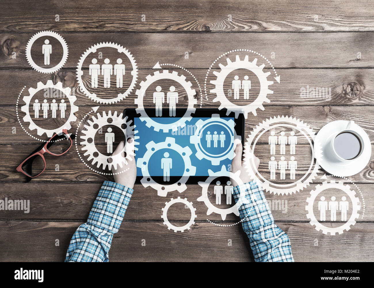 Concept of teamworking and connection with gears mechanism and tablet ...