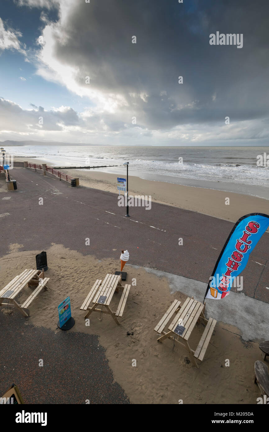 Rhyl Beach side cafe tables on the promenade Stock Photo - Alamy