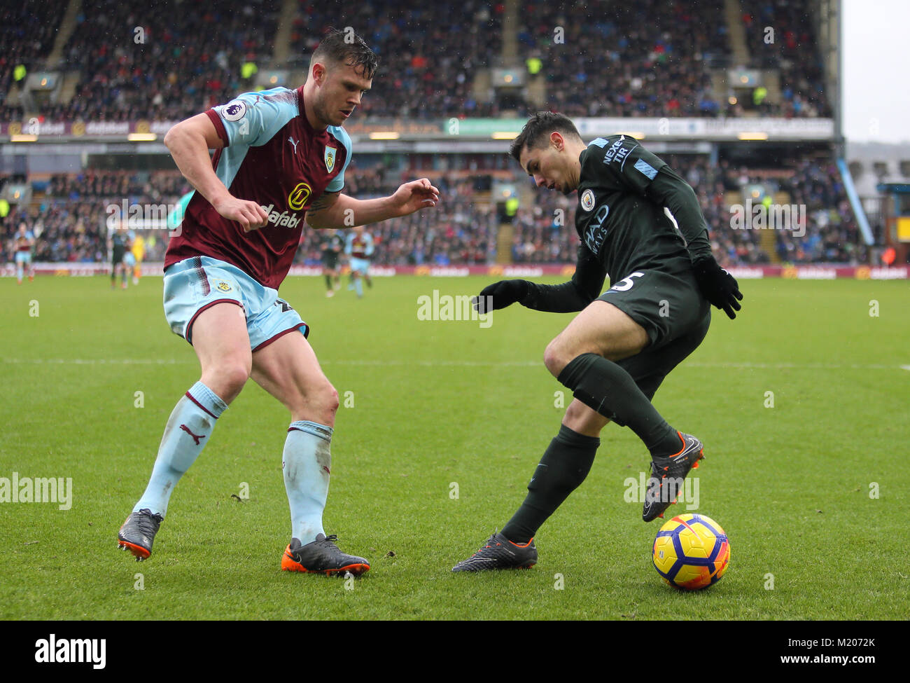 Burnley's Kevin Long (left) and Manchester City's Brahim Diaz battle ...