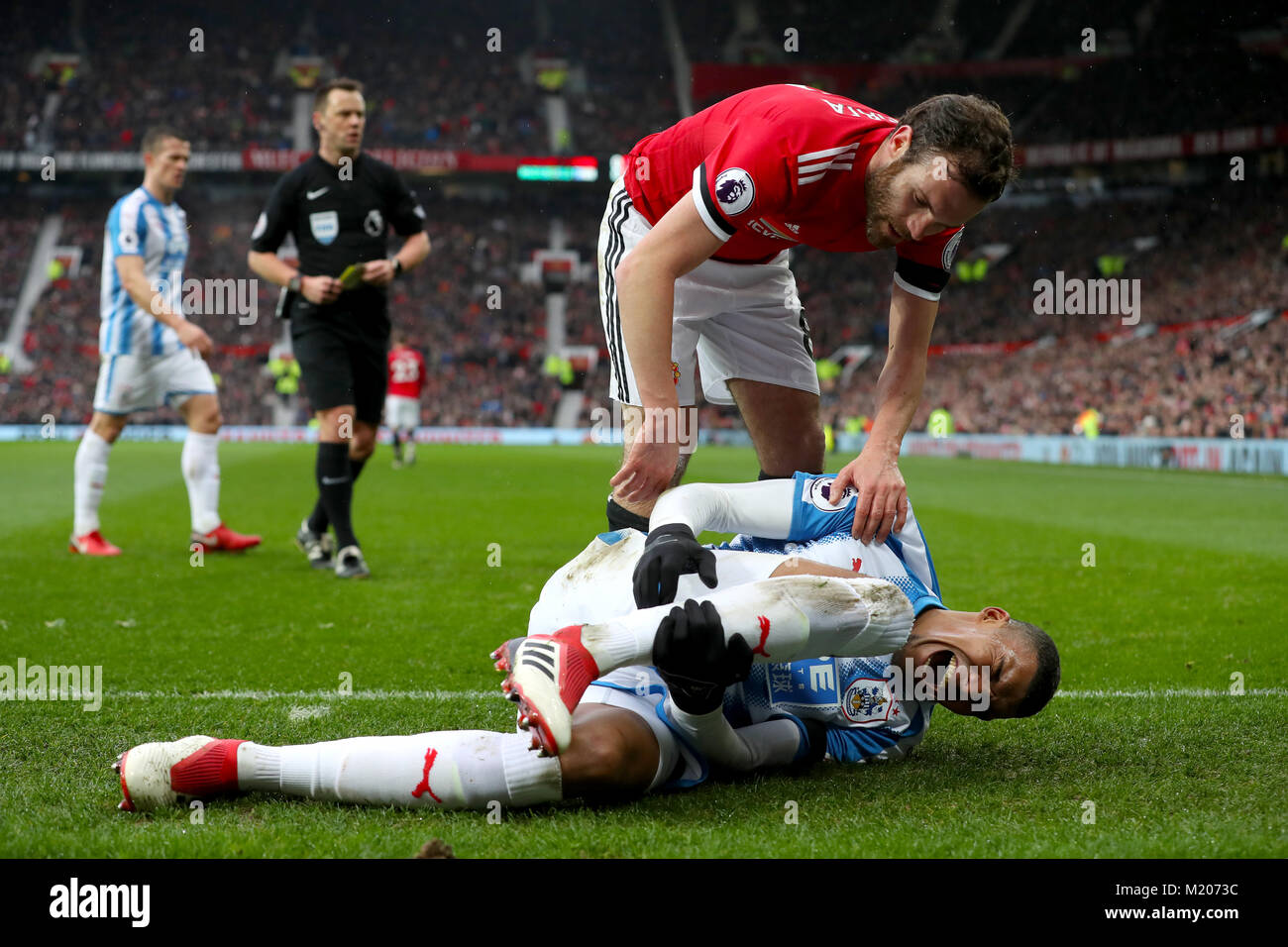 Huddersfield Town's Collin Quaner clutches his after a challenge by ...