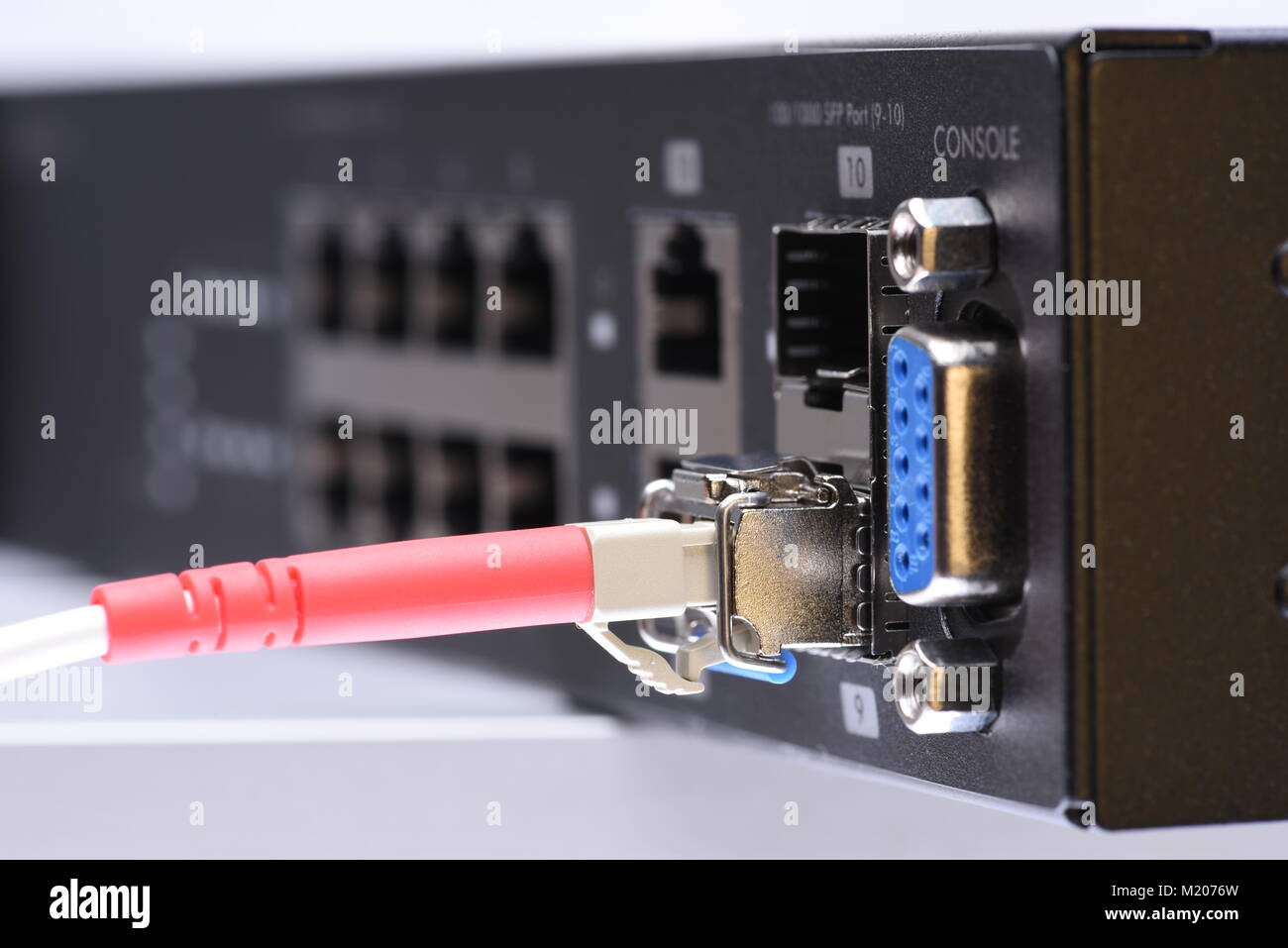 Network devices technology, optical fiber cable and switch, close-up on ...