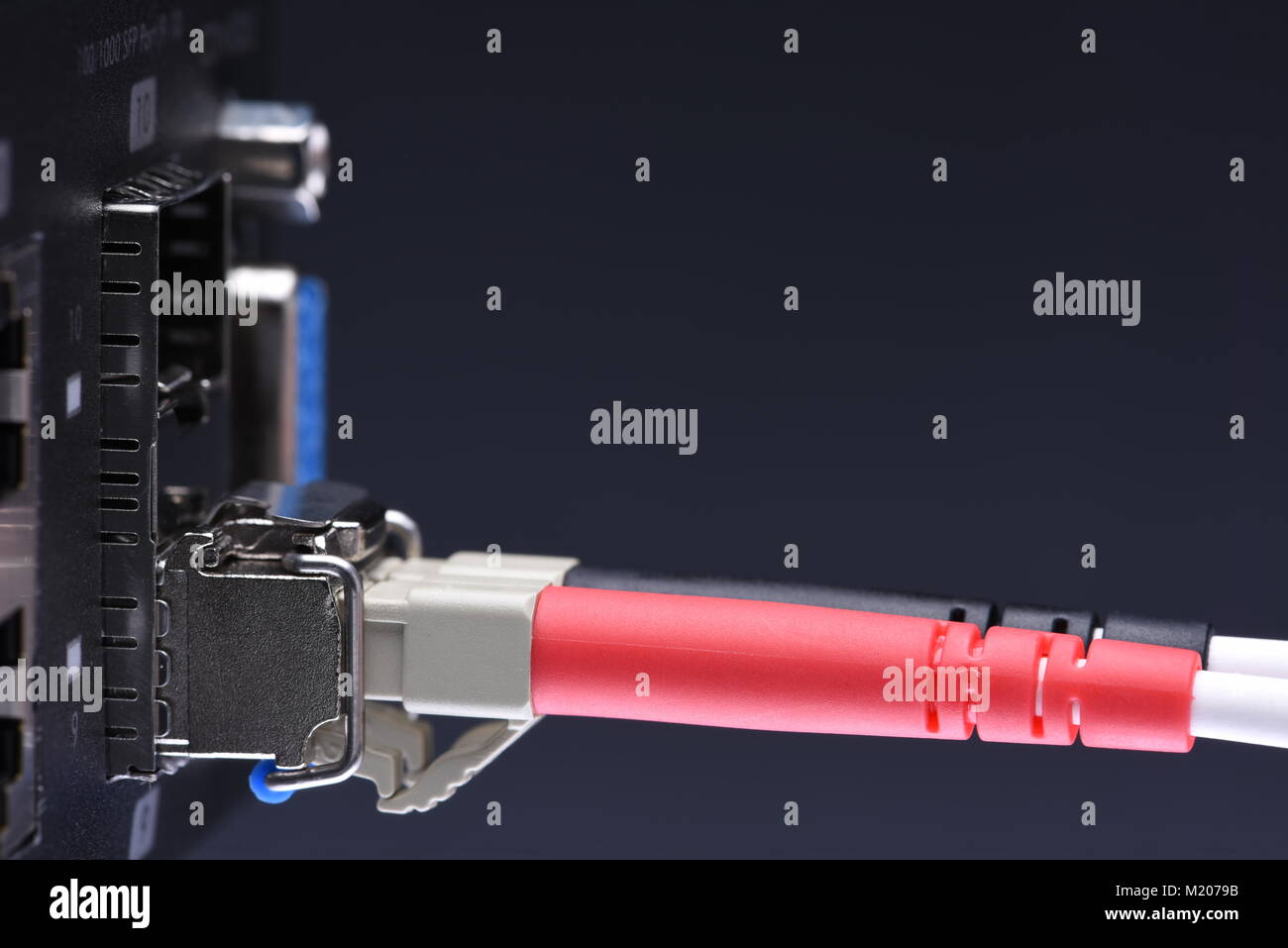 Network devices technology, optical fiber cable and switch, close-up on ...