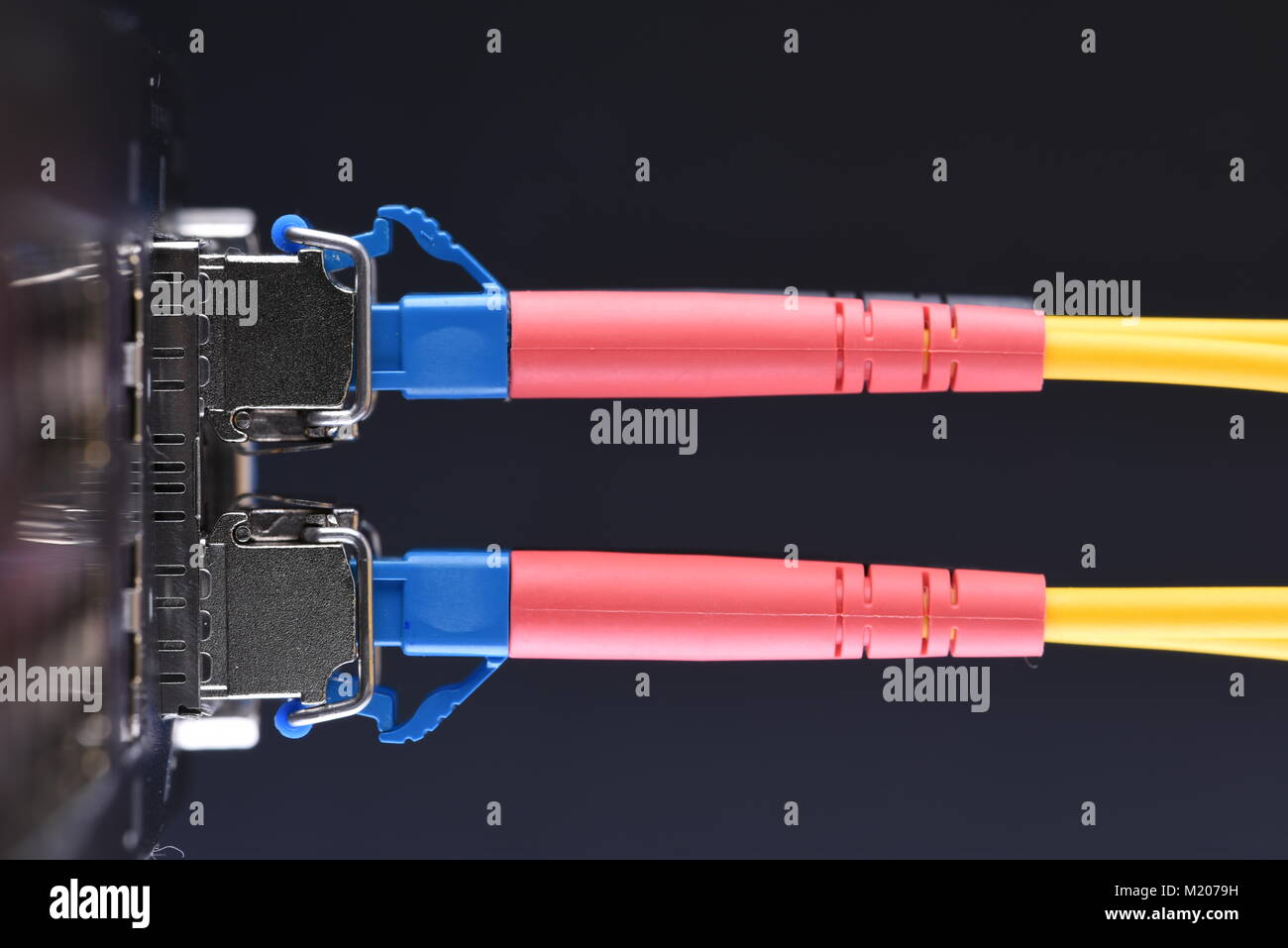 Network devices technology, optical fiber cable and switch, close-up on ...