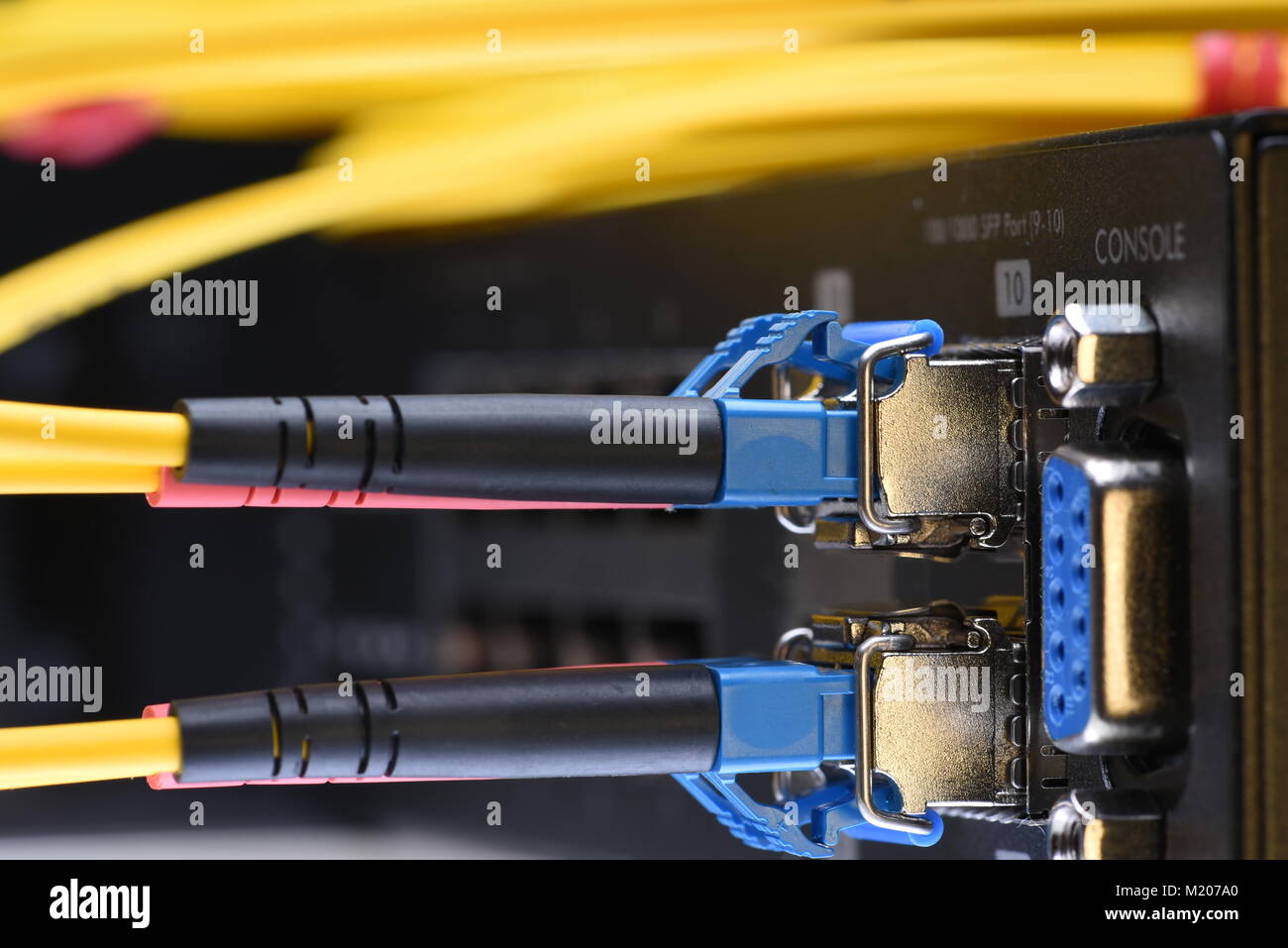 Network optic fiber cables and switch in data center close-up Stock ...
