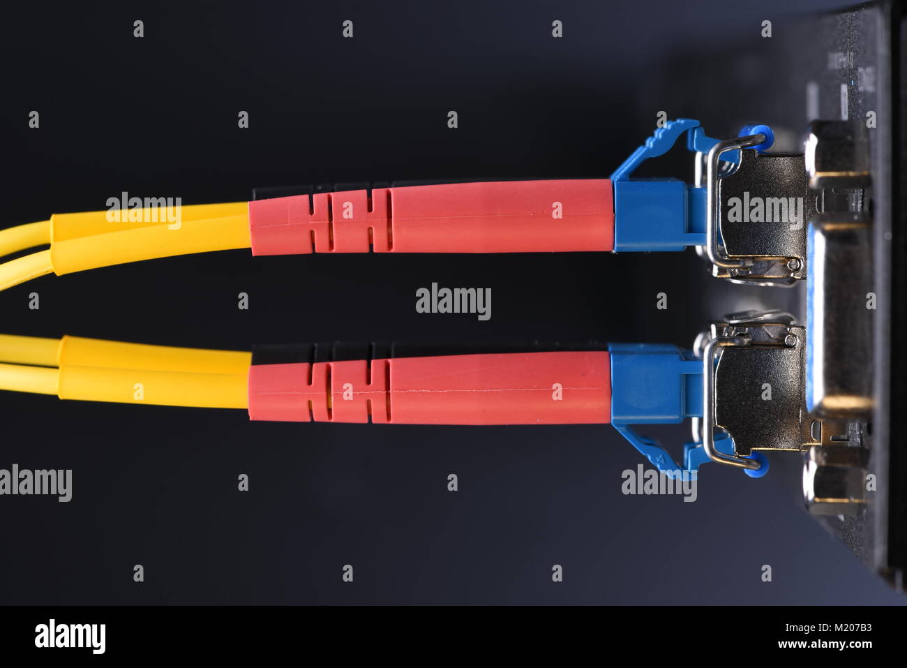 Network devices technology, optical fiber cable and switch, close-up on ...