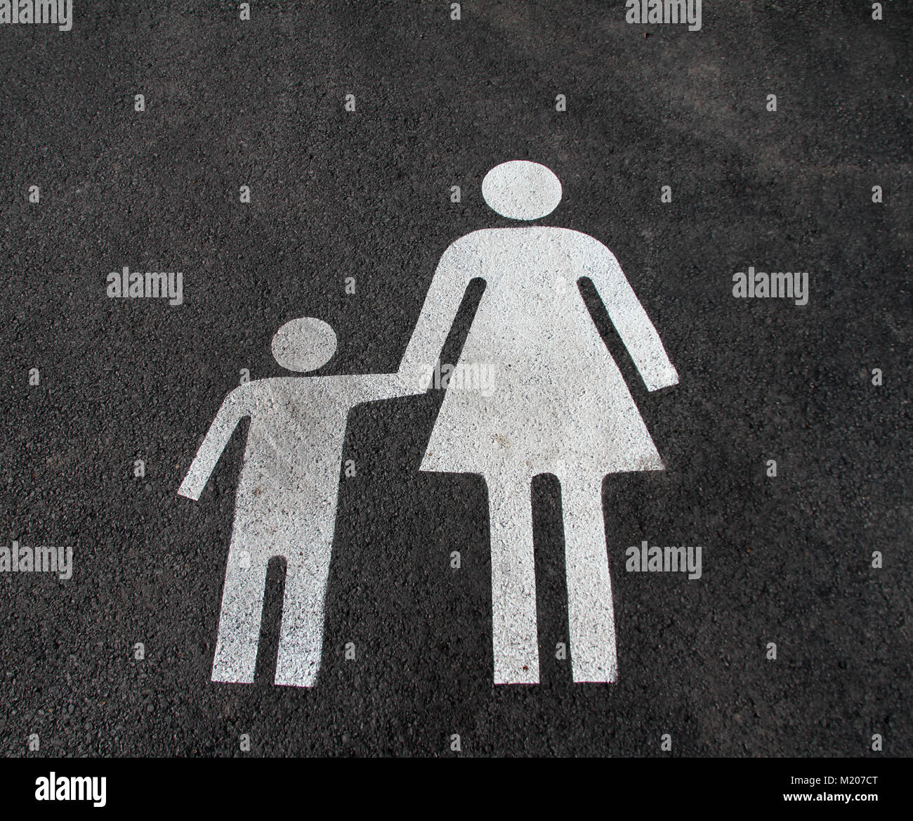 Parking space for mothers and children. Sign on asphalt “Mother and ...