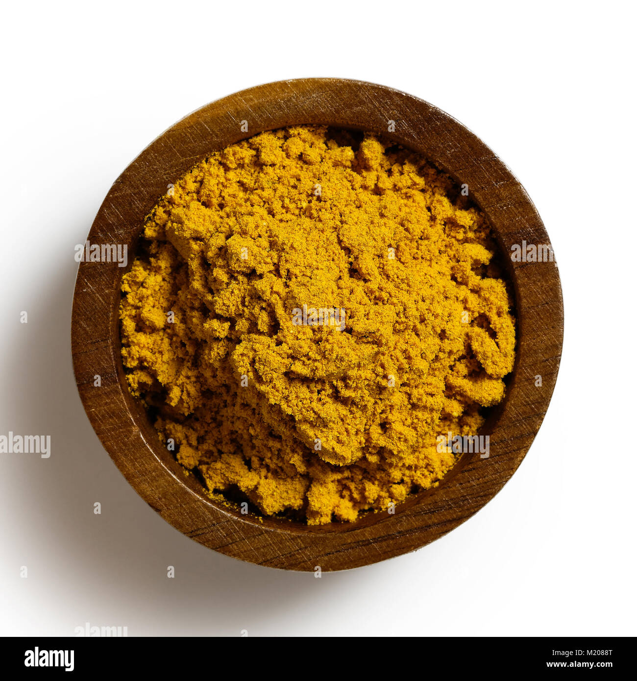 Curry powder in dark wood bowl isolated on white from above Stock Photo ...
