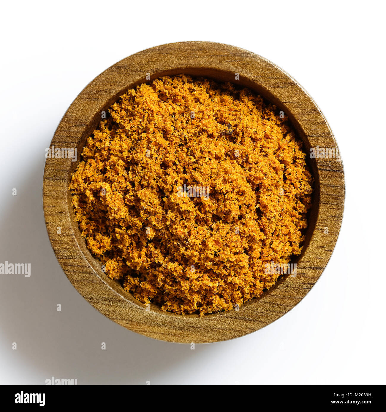 Ground dry mace in dark wood bowl isolated on white from above Stock ...