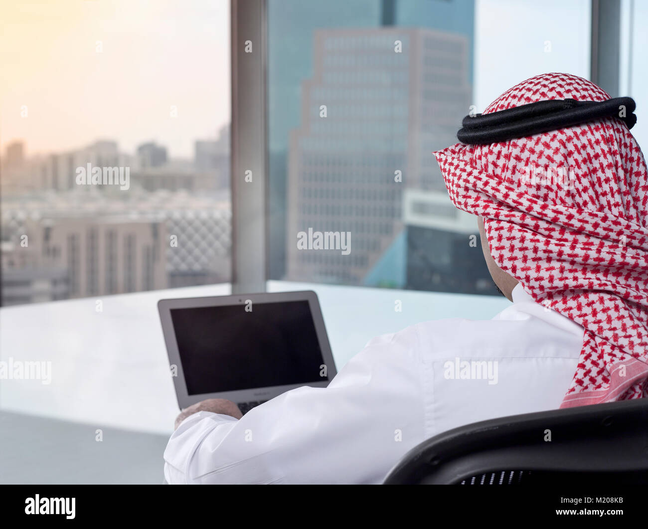 Saudi Arab Man Watching Laptop at Work and Contemplating Stock Photo ...