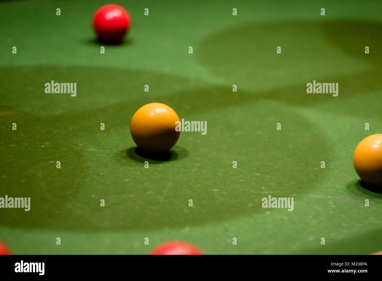A yellow pool ball isolated on the table, a background of green cloth ...