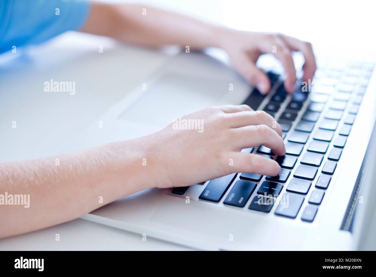 Boy using laptop keyboard, close up Stock Photo - Alamy