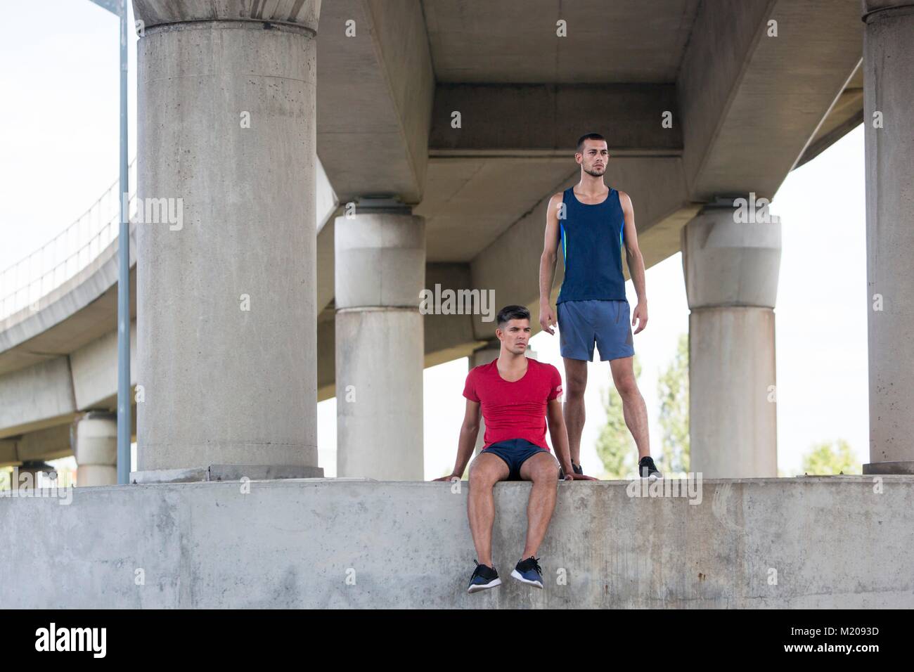 Two male athletes under concrete bridge Stock Photo - Alamy