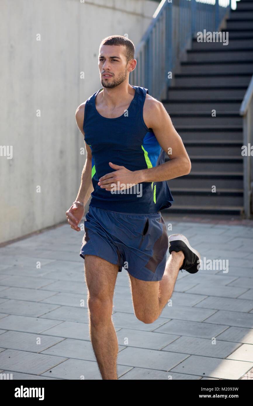 Young man running past steps hi-res stock photography and images - Alamy