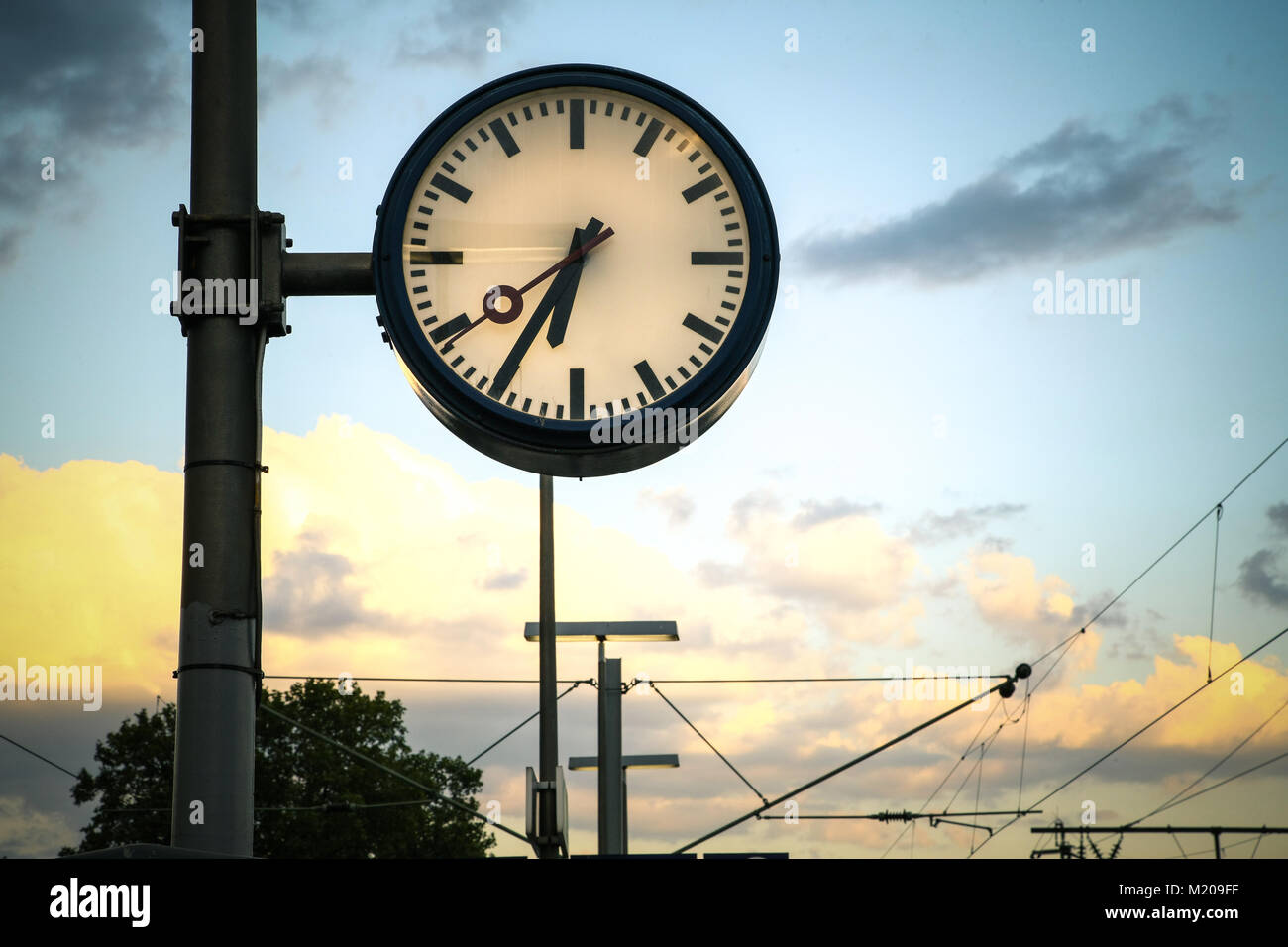 Street clock. Hanging clock on city walk. Clock in the rain station ...