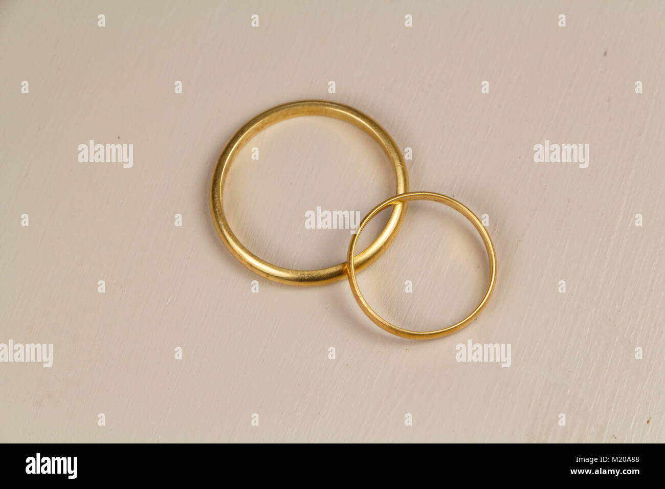 Two wedding rings of different sizes made in gold Stock Photo - Alamy