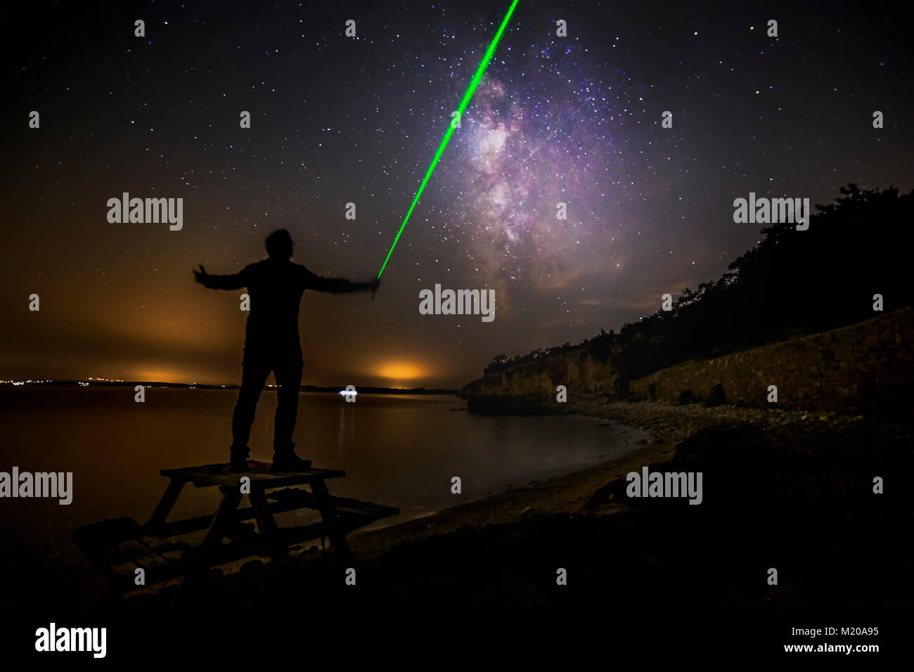 Single man with his laser pointer like lightsaber and milkyway Stock ...