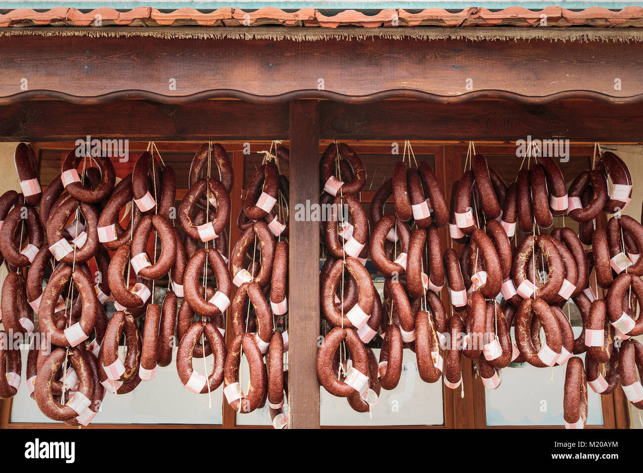 Too many fermented sausage hanging on the string Stock Photo - Alamy