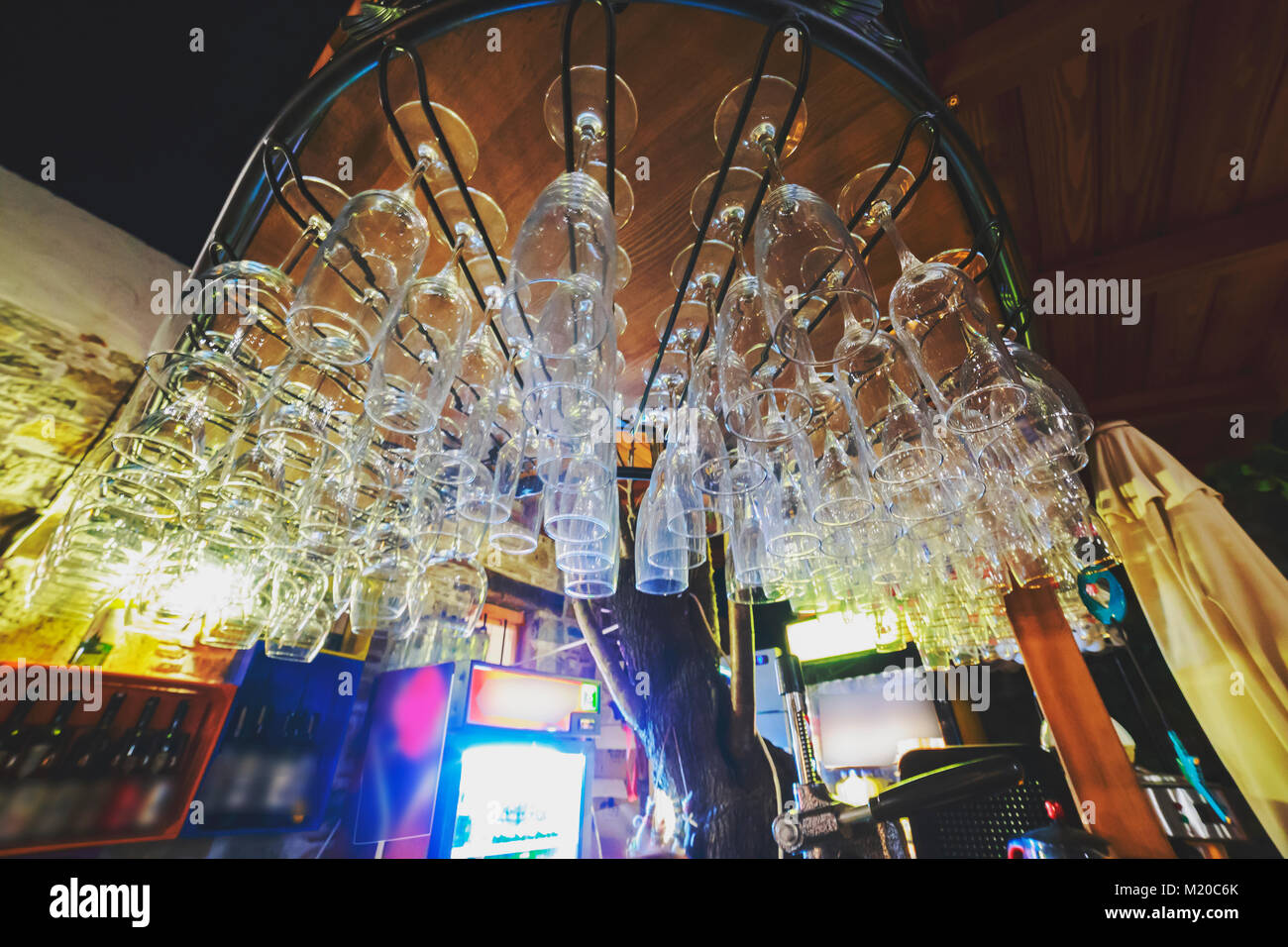 Several types of bar glasses hangs over the bar Stock Photo - Alamy