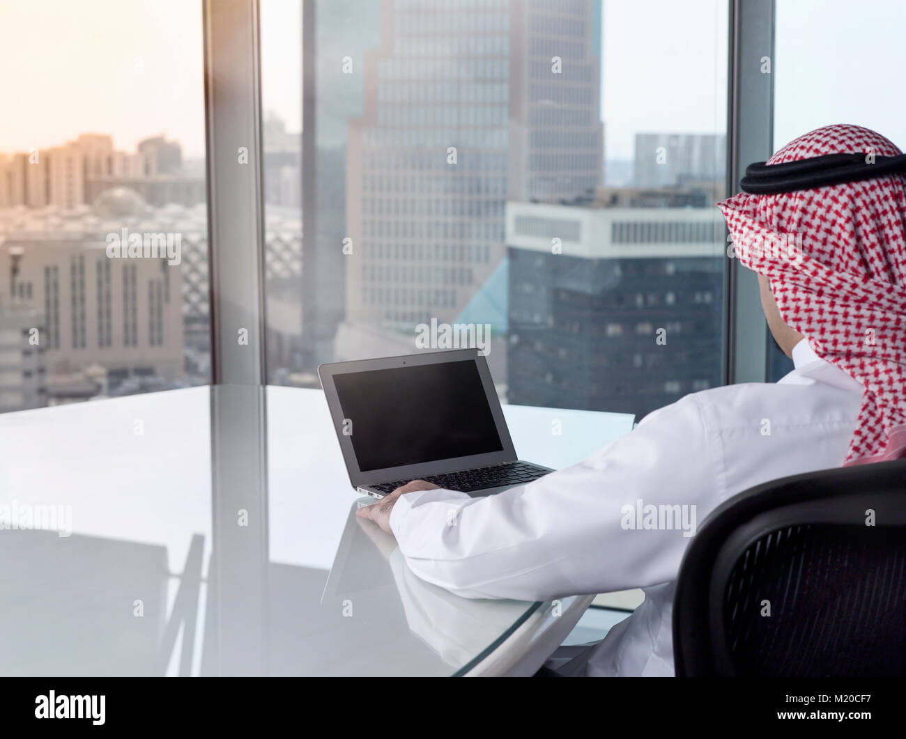 Saudi Arab Man Watching Laptop at Work and Contemplating Stock Photo ...