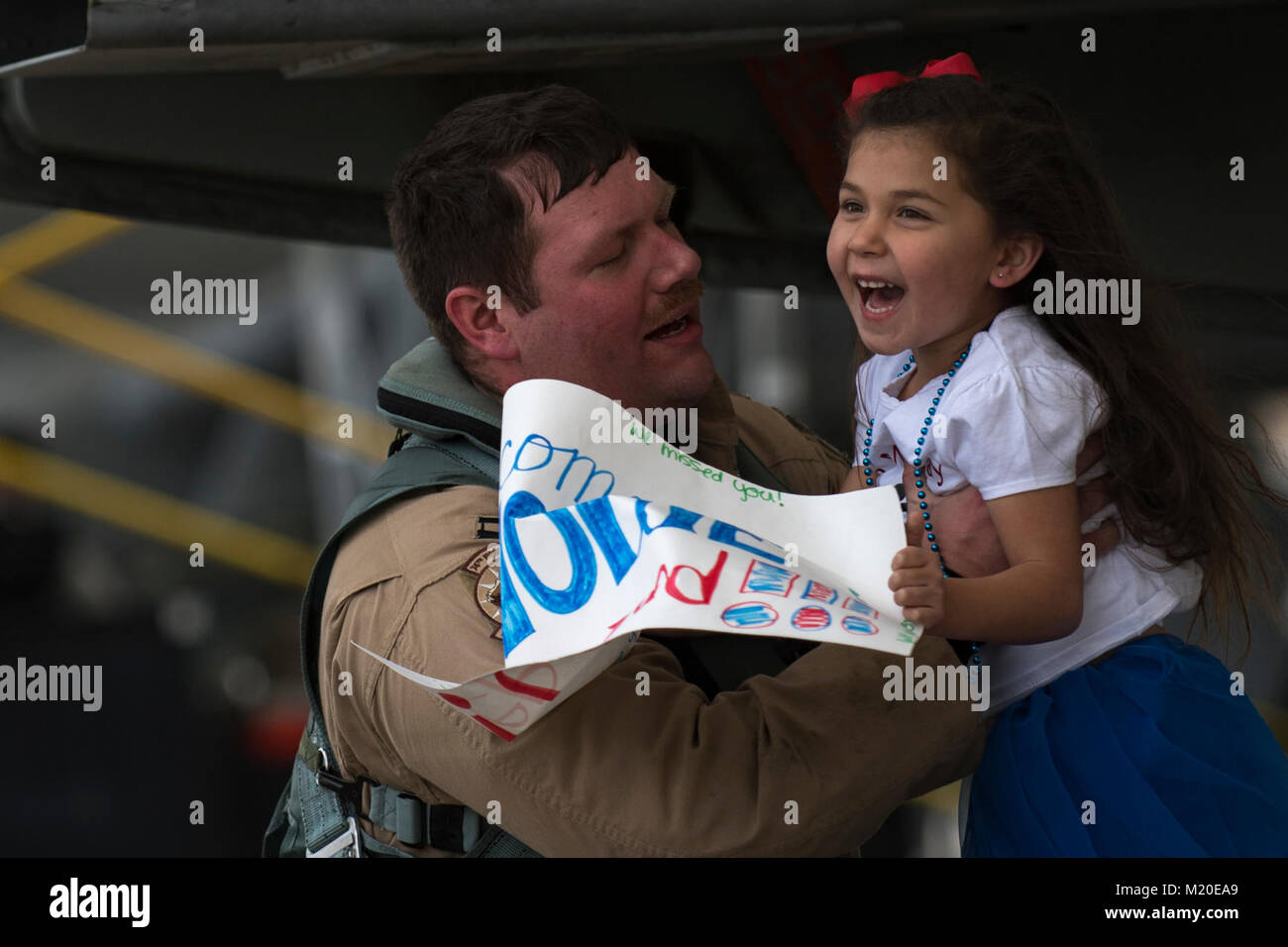 Capt. Brendan Lanphear, 74th Fighter Squadron pilot, lifts his daughter ...