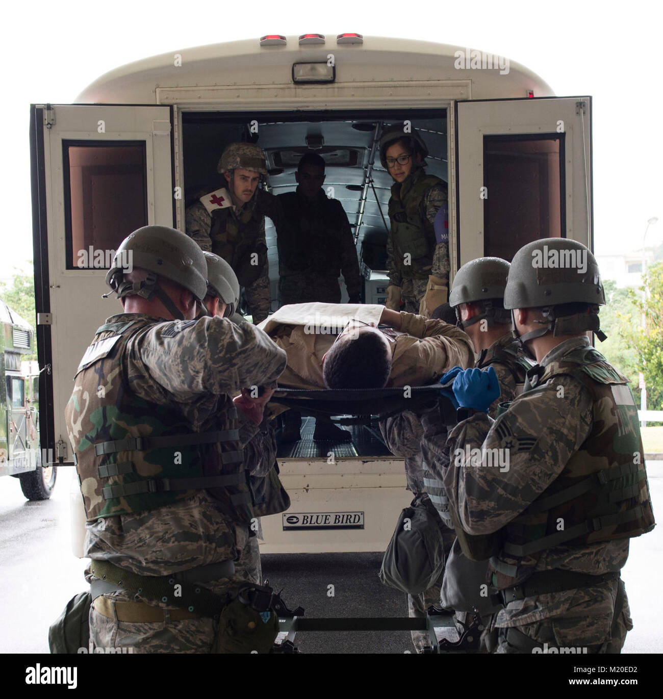 A simulated patient is loaded for transportation during a joint field ...