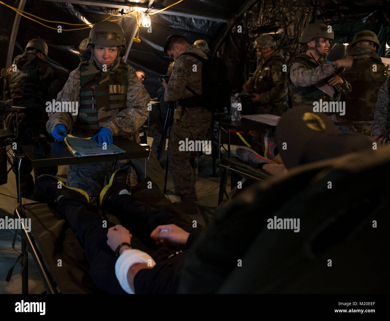 Volunteers recieve simulated medical care in an En Route Patient ...