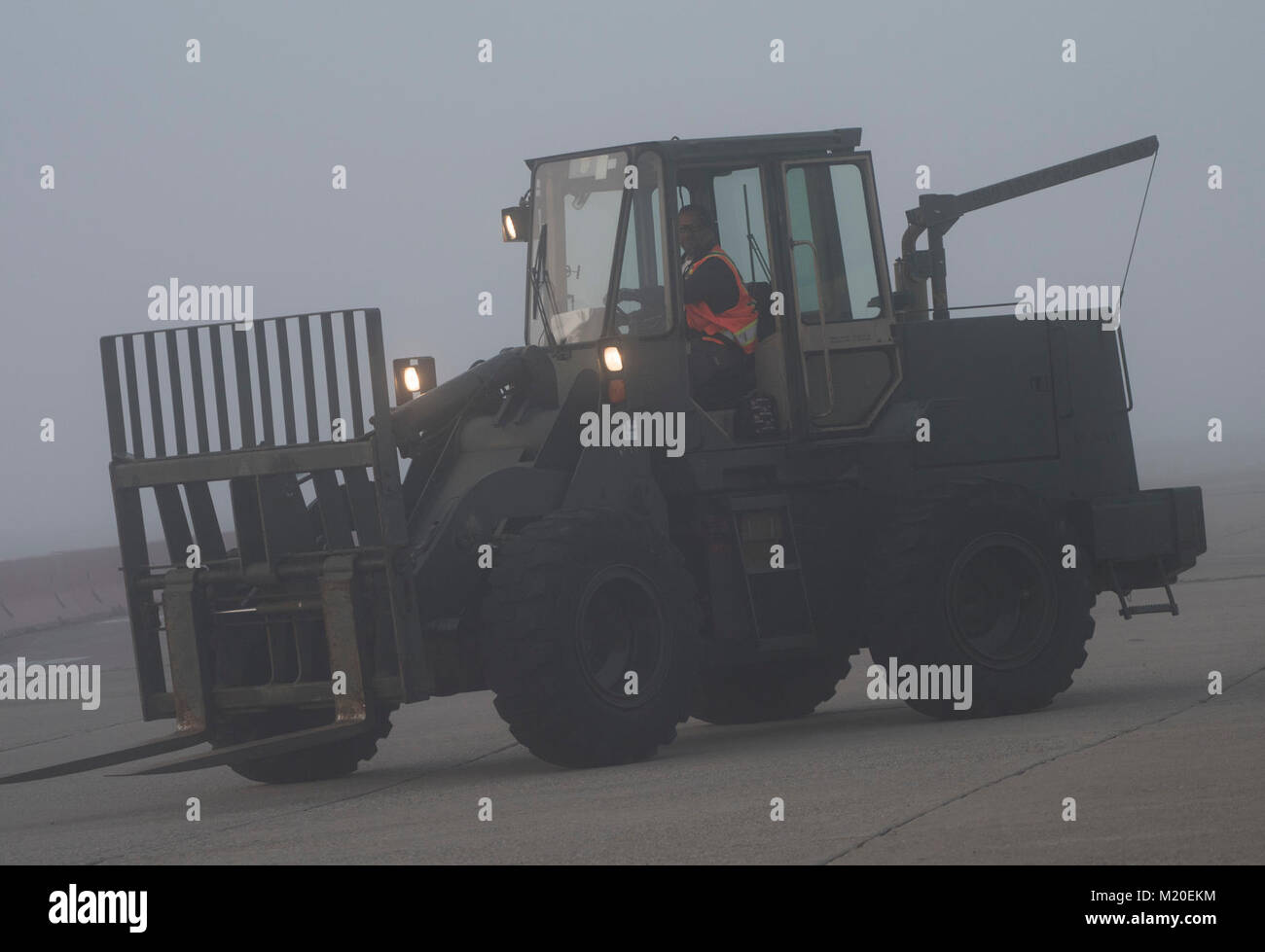An Airmen assigned to the 60th Aerial Port Squadron uses a forklift to ...