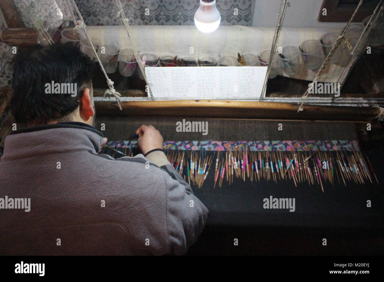 A Kashmiri craftsman weaves a special Kani shawl on a handloom with ...